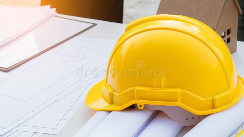 The Yellow Engineer Hat is on the Document and There is a House in the ...