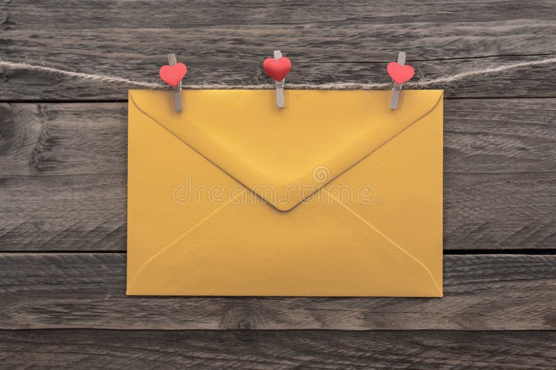 Yellow Envelope with Hearts Hanging on a String. Message Concept. Stock ...
