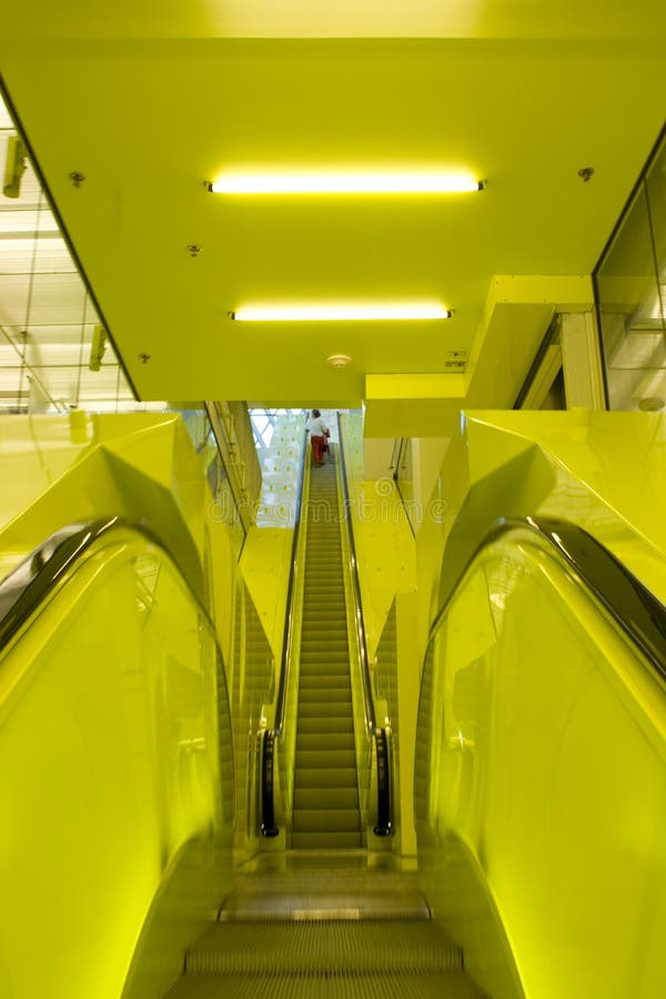 Yellow Escalator and Blue Roof Stock Image - Image of public, long ...