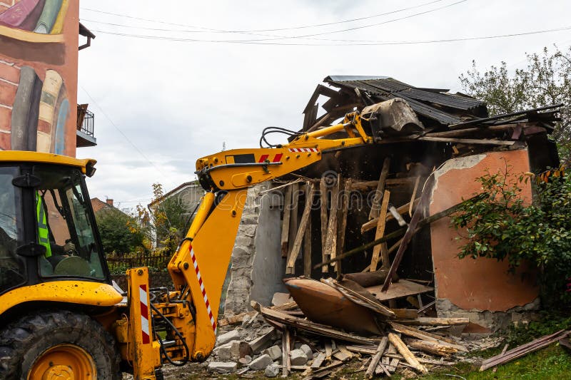 Heavy Machinery Demolishes a Deteriorating Building in an Urban Area ...