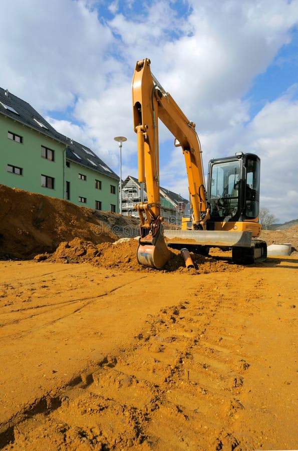 Yellow Excavator on the Construction Site Stock Photo - Image of blue ...