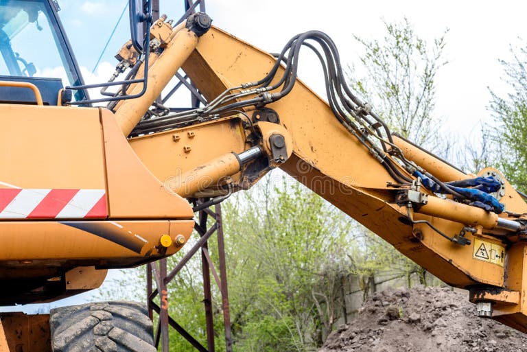 The Modern Excavator Performs Excavation Work on the Construction Site ...