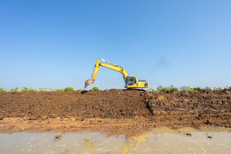 Yellow Excavator Digging. Digger Machine Adjusting Ground Level in ...