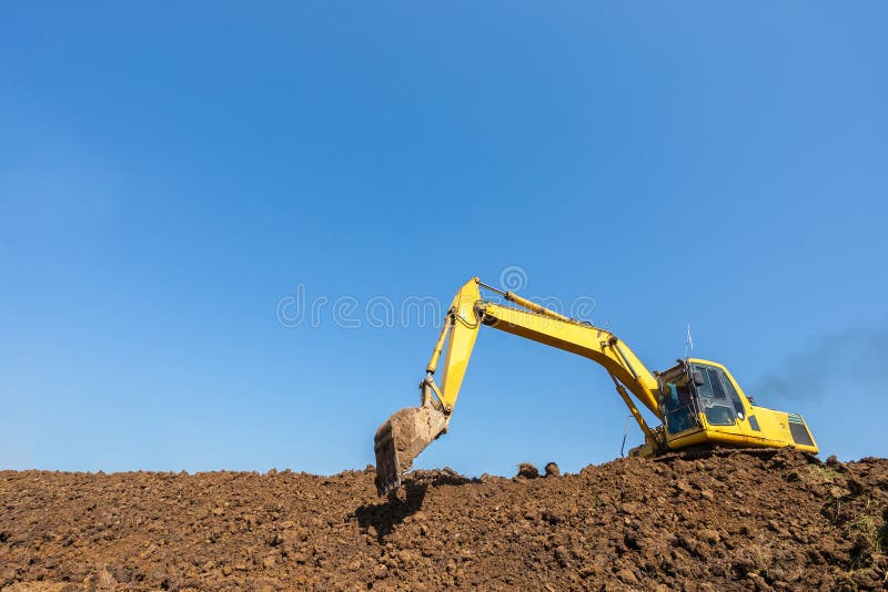 Yellow Excavator Digging. Digger Machine Adjusting Ground Level in ...