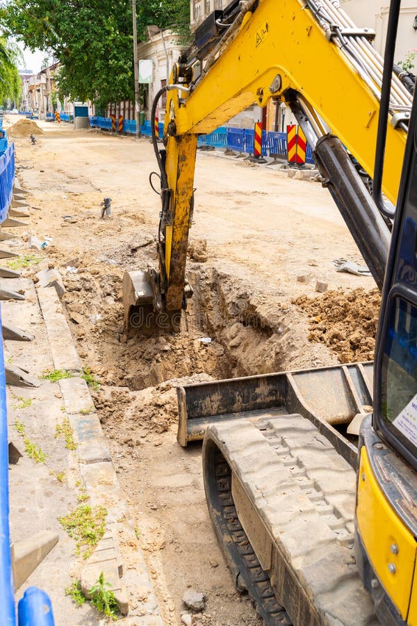 Excavator Work. the Iron Ladle Digs into the Ground. Digging a Hole ...
