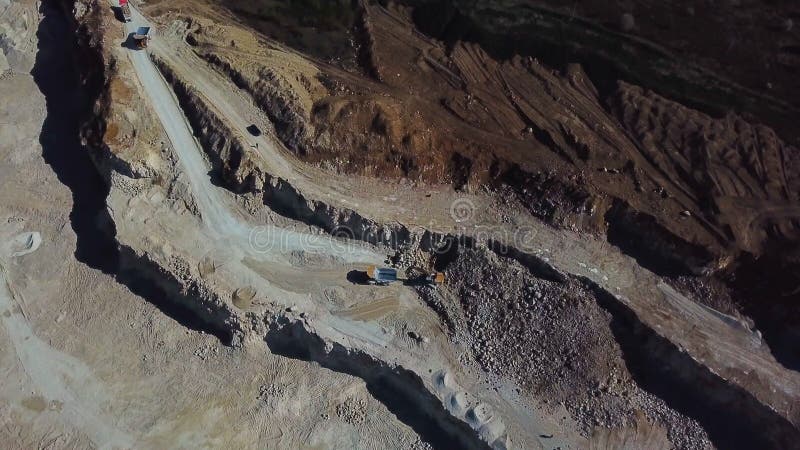 Yellow Excavator Loading Soil into a Dumper Truck on Construction Site ...