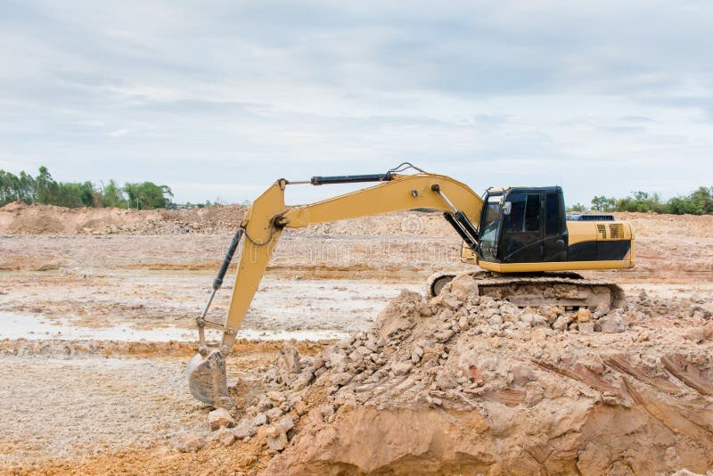 Yellow Excavator Machine Loading Soil into a Dump Truck at Construction ...