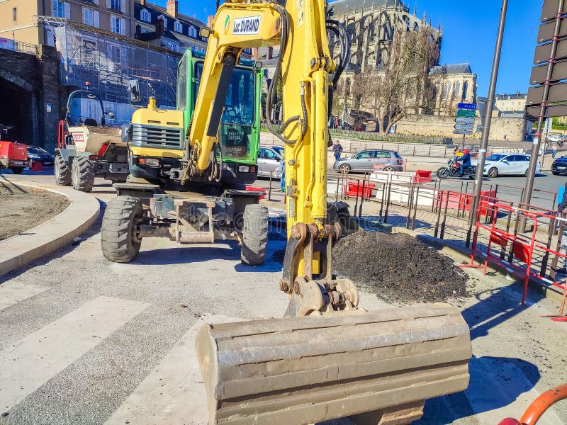 Yellow Excavator Working on Construction Site with Urban Background ...