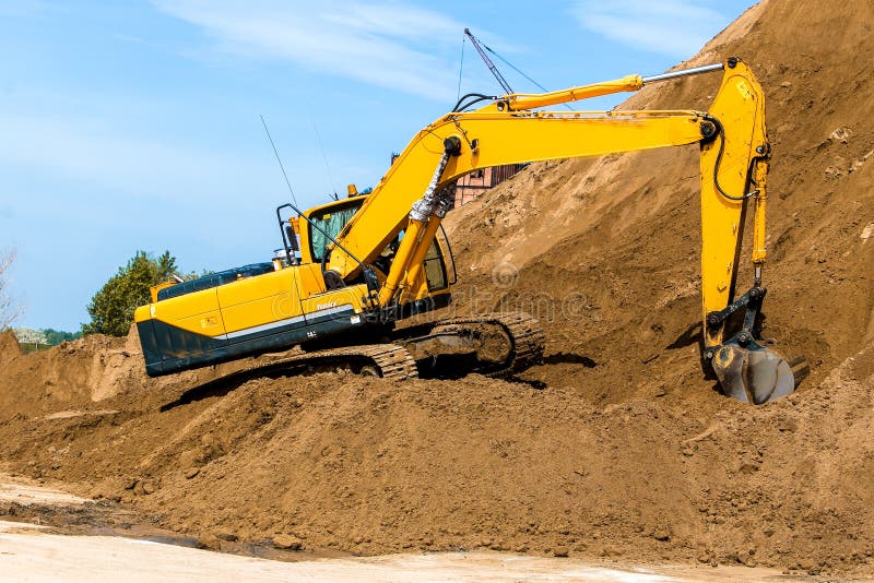 Yellow Excavator Working and Digging in Sand Stock Photo - Image of ...
