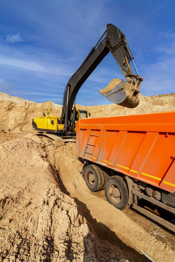 Yellow Excavator Working with Sand at Construction Site Stock Photo ...