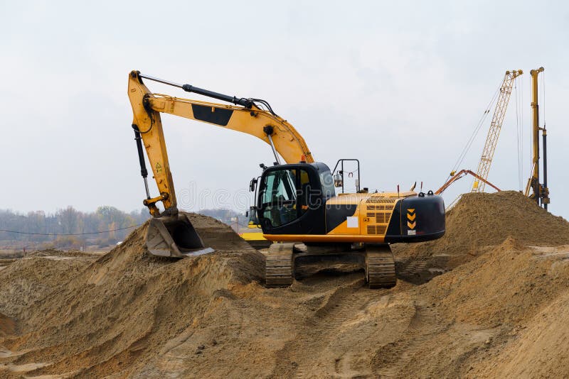 Yellow Excavator is Working on a Sand Embankment Stock Image - Image of ...