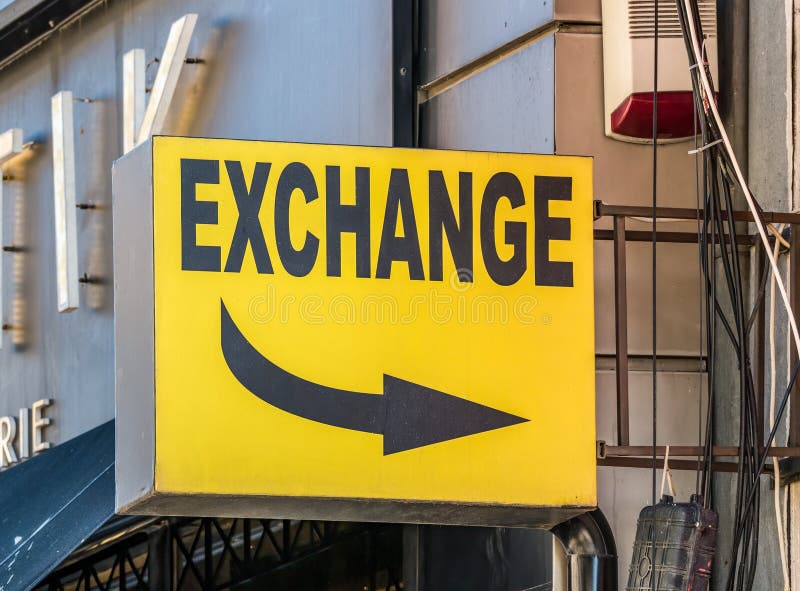 Yellow Exchange Sign Board with a Black Arrow Pointing in the Direction ...