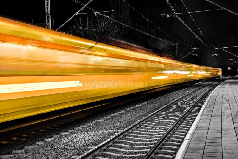 A Yellow Express Train Passing through the Railway Station Stock Photo ...