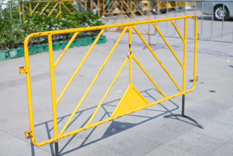 Yellow Fence in the Parking Lot. Stock Image - Image of street, people ...