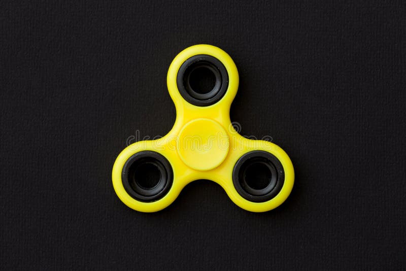 Yellow Fidget Spinner Device on Black Background. Top View Stock Photo ...