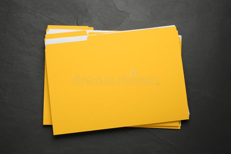 Yellow Files with Documents on Black Slate Table, Top View Stock Photo ...