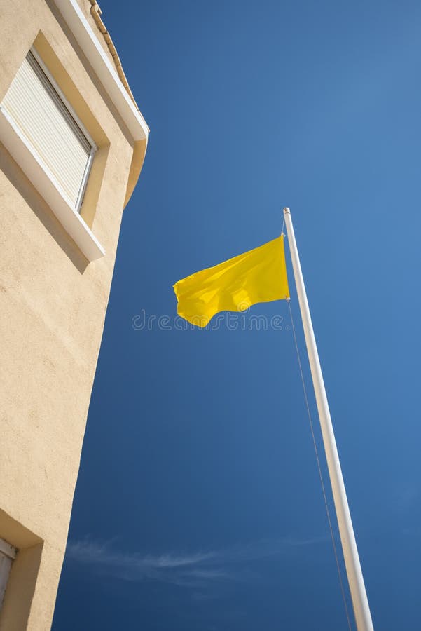 Yellow flag at beach stock photo. Image of symbol, instruction - 148671152