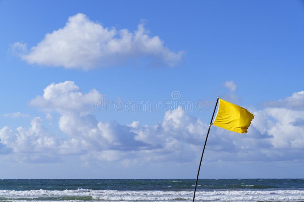 The Yellow Flag is a Warning of Caution or Danger on the Beach Stock ...