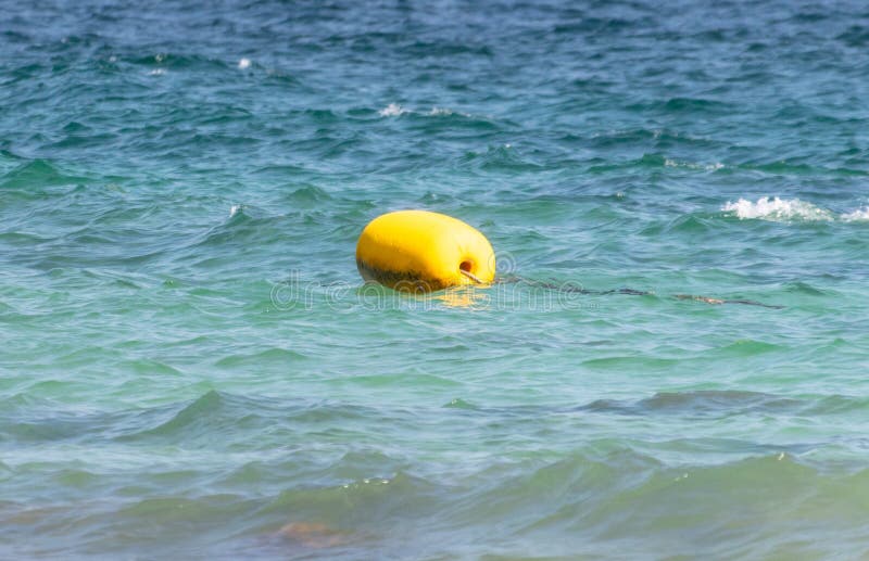 A Yellow Float Floats in the Sea Stock Image - Image of sandy, buoy ...