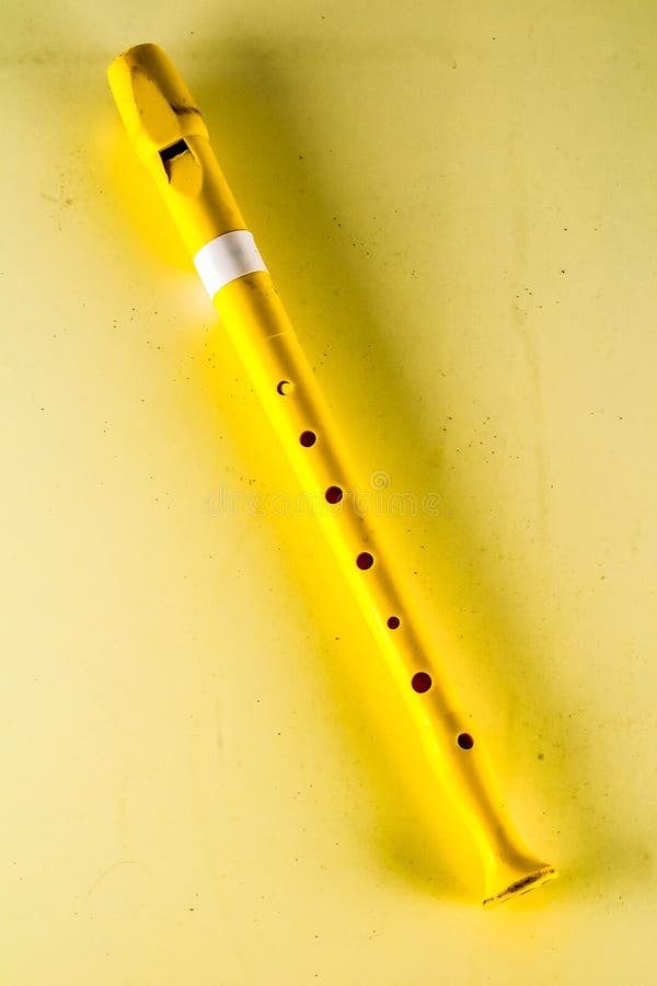 A Yellow Flute is Sitting on a Yellow Surface Stock Photo - Image of ...