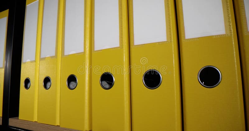 Yellow Folders for Documents Put in Line on Shelf of Rack Stock Video ...