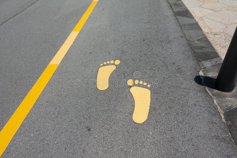 Yellow Foot Symbol for Walk Path on Road Stock Photo - Image of human ...