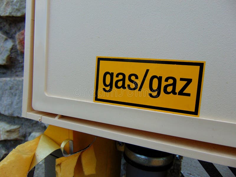 Yellow Gas Sign on White Box of House Stock Image - Image of sign ...