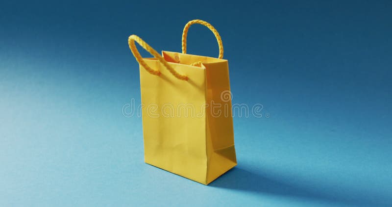 Yellow Gift Bag with String Handles String on Blue Background Stock ...
