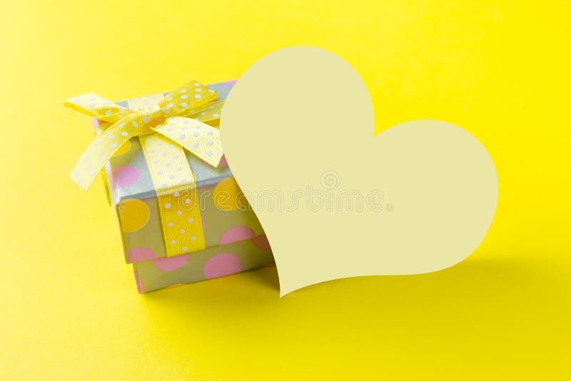 A Yellow Gift Box with Black Ribbon Puts on Black and Yellow Background ...