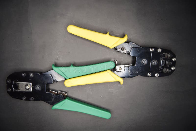 Yellow and Green Adjustable Wire Stripper Isolated on a Black ...