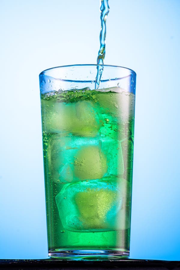 Yellow or Green Carbonated Lemonade in a Glass with Ice, Flow and ...