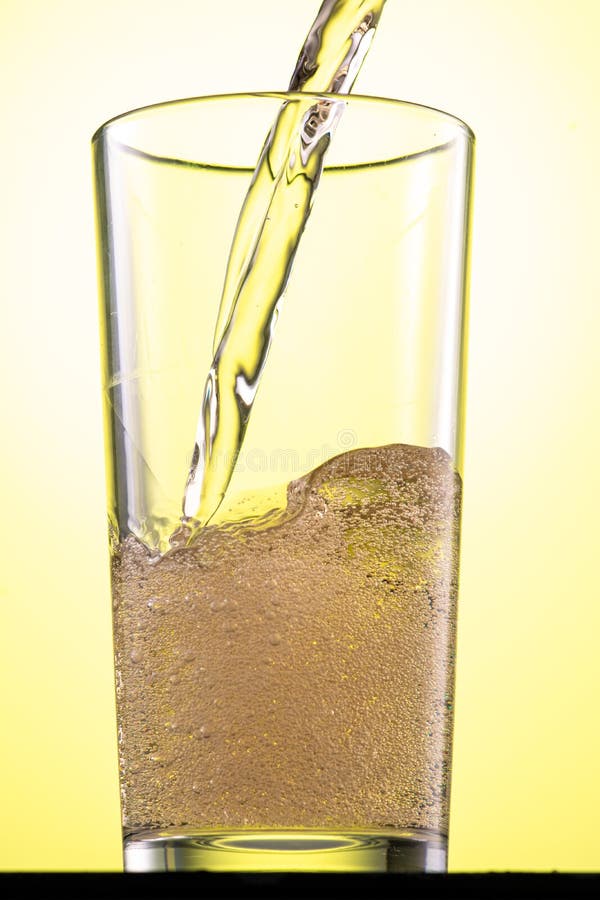 Yellow or Green Carbonated Lemonade in a Glass with Ice, Flow and ...