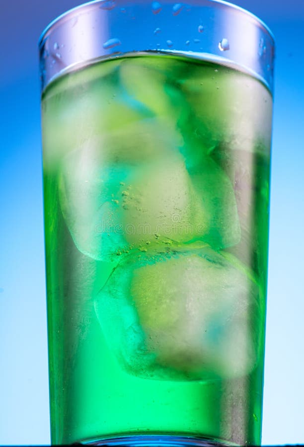 Yellow or Green Carbonated Lemonade in a Glass with Ice, Flow and ...