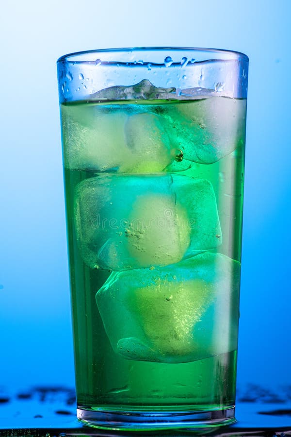 Yellow or Green Carbonated Lemonade in a Glass with Ice, Flow and ...