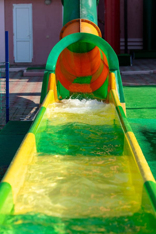 Yellow-green Slide in the Pool of the Water Park Stock Image - Image of ...