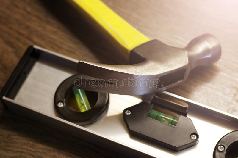 Yellow Hammer and Level for Repair and Construction Stock Photo - Image ...