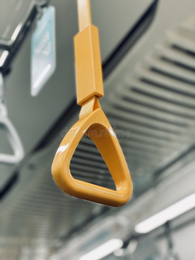 Yellow Handle Grip at MRT stock image. Image of people - 276167601