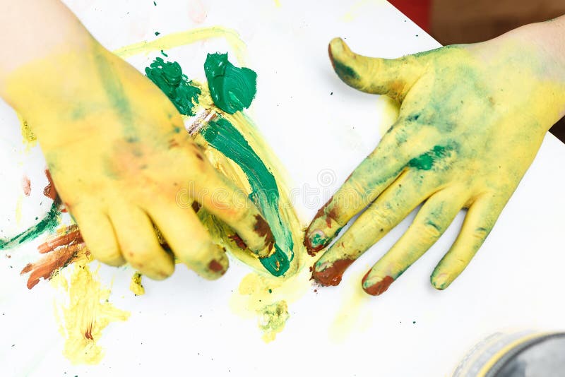 Yellow Hands in Paints on Light Table Painted in Different Colors Stock ...