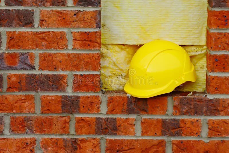 Yellow Hard Hat on Top of Red Brick Wall Stock Photo - Image of bricks ...