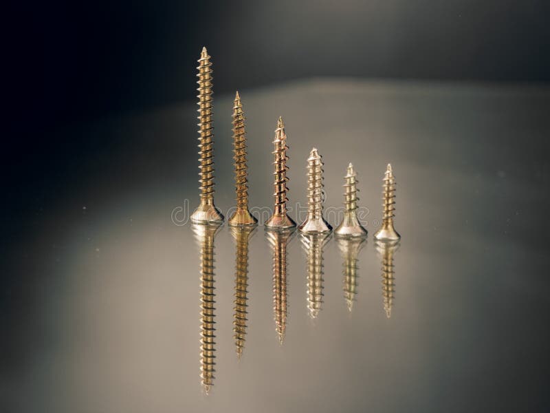 Yellow Hardware Screws on a Black Background Stock Image - Image of ...