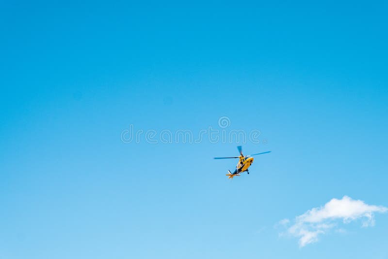 A Yellow Helicopter Flying in the Blue Sky Stock Image - Image of ...