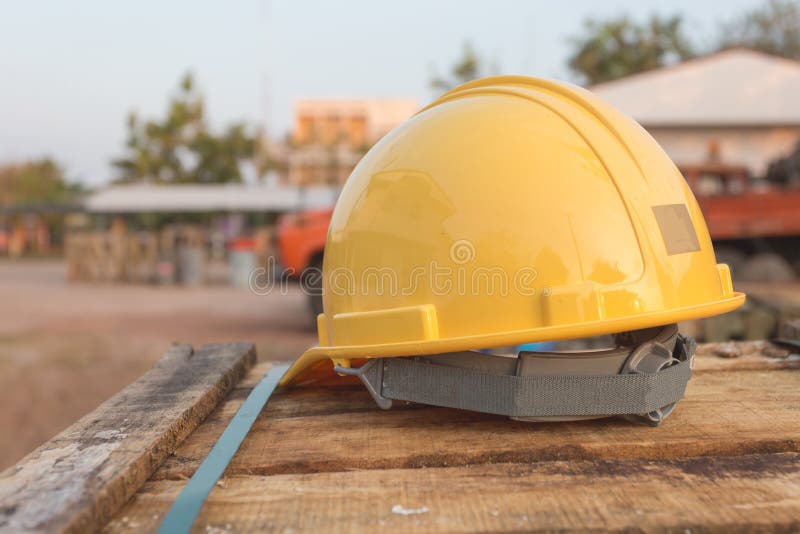 Yellow Helmet for Engineering on Wooden Box Stock Image - Image of ...