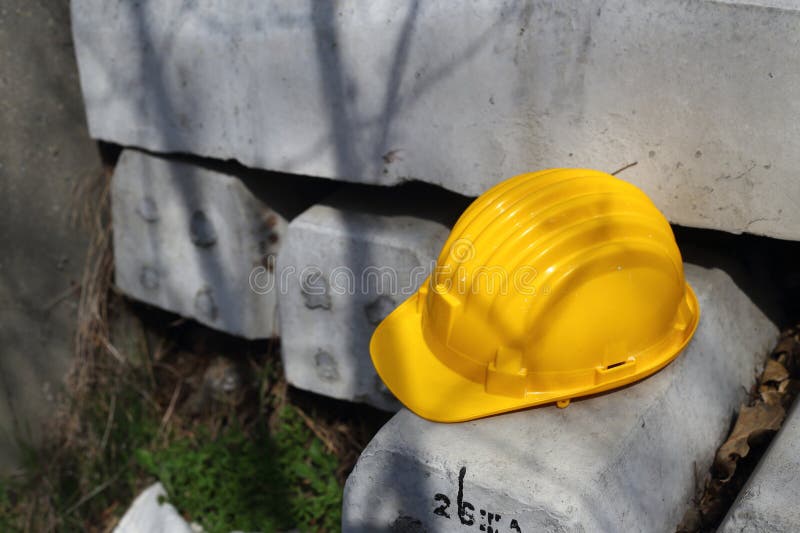 Yellow Helmet on a Work Site Stock Image - Image of build, hardhat ...