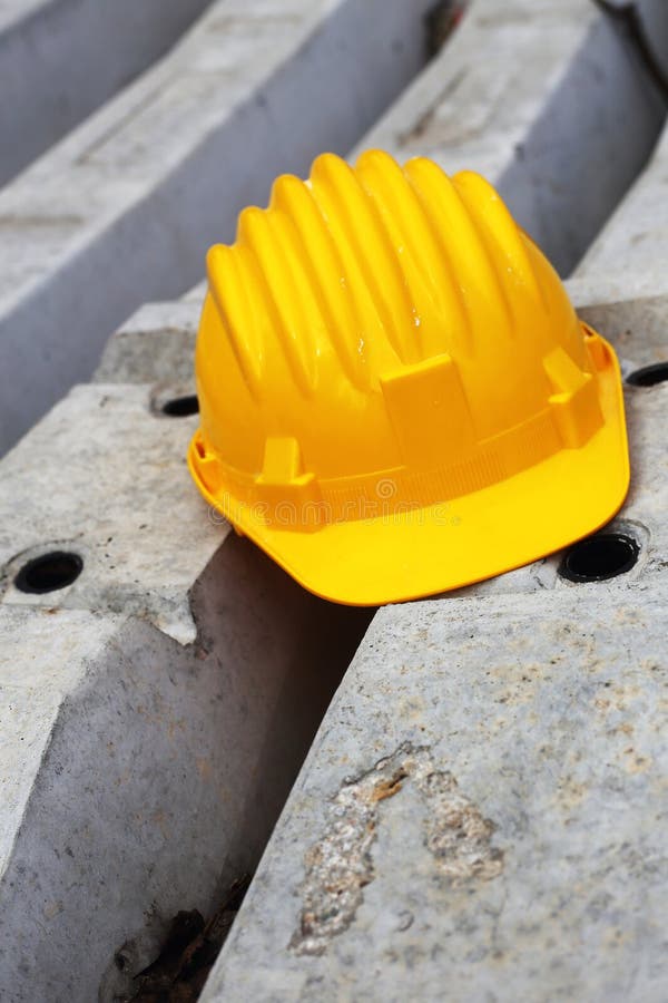 Yellow Helmet on a Work Site Stock Image - Image of head, background ...