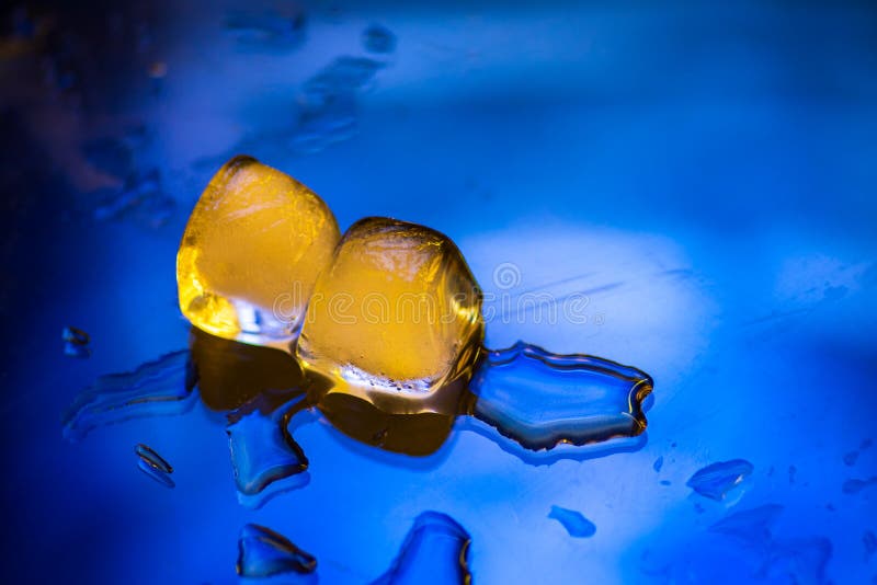 Yellow Ice Cubes on Blue Glass Stock Image - Image of drink, dark ...