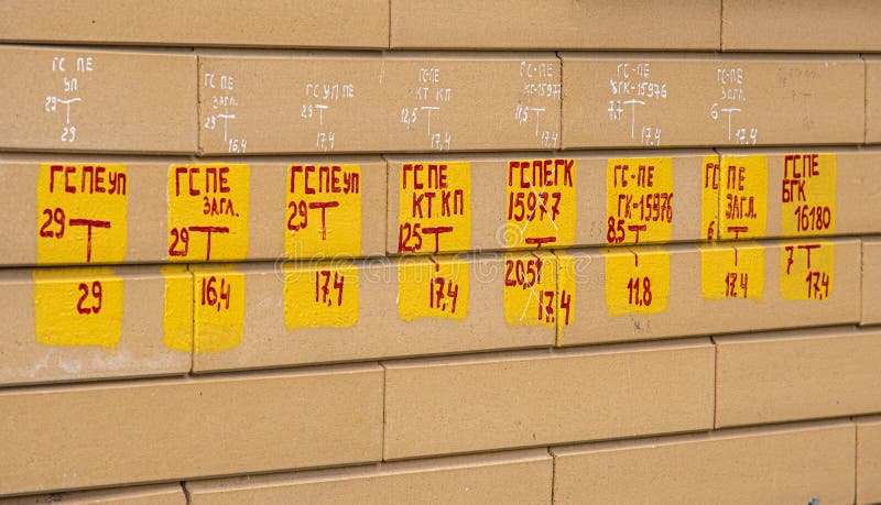 Yellow Identification Marks of Underground Utilities on the Wall of the ...