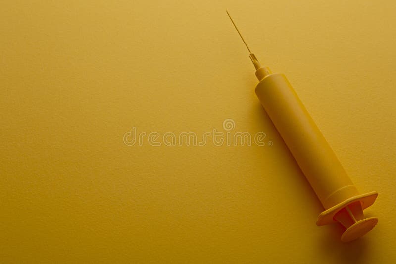 Yellow Injection Syringe on Yellow Background Stock Photo - Image of ...