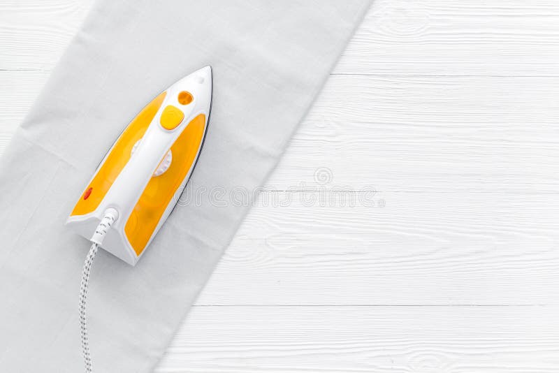 Yellow Iron with Clean Linen on Ironing Board. Top View, Copy Space ...