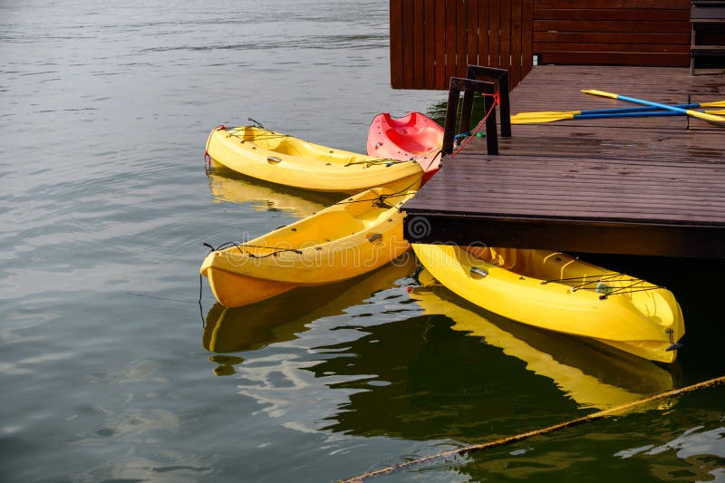 Yellow Kayak with Paddles Floating on Lake Stock Image - Image of ...
