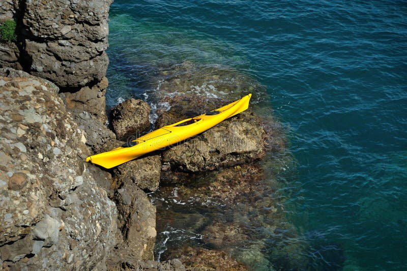 Yellow Kayak on the Rocky Shore Stock Image - Image of sand, bright ...